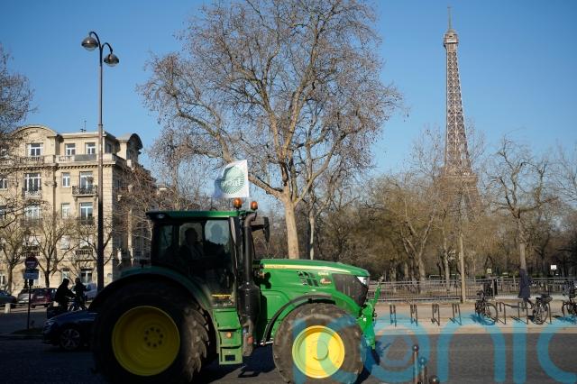 Farmers drive hundreds of tractors to Paris to protest against ...